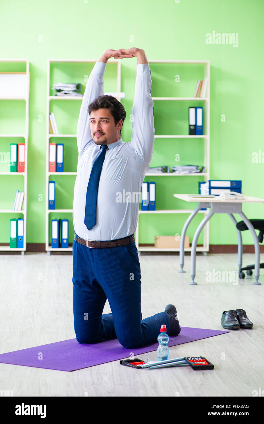 Employee doing exercises during break at work Stock Photo - Alamy