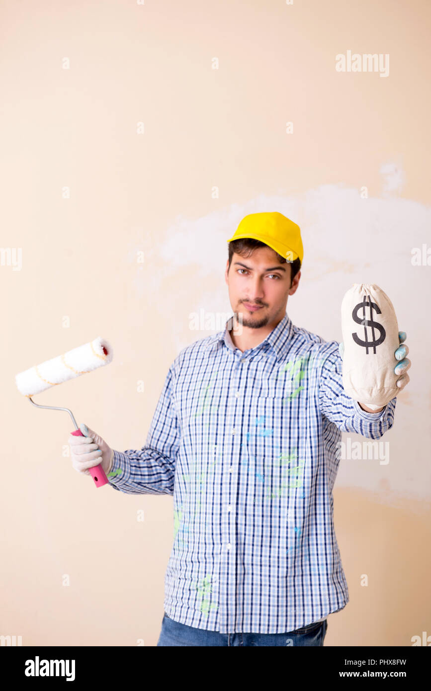 Painter man painting the wall at home Stock Photo - Alamy