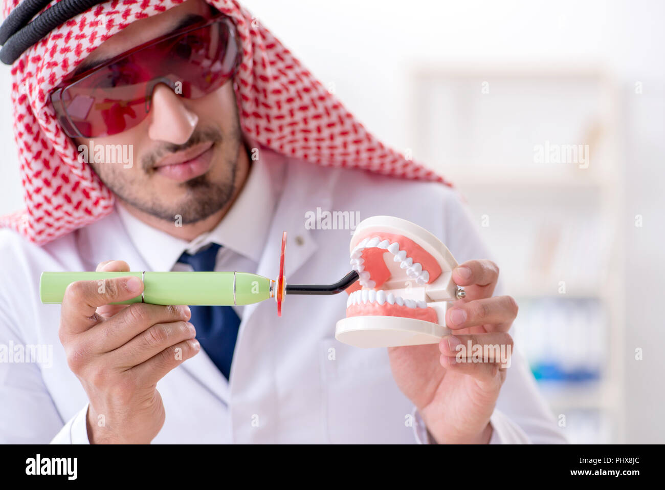 Arab dentist working on new teeth implant Stock Photo - Alamy