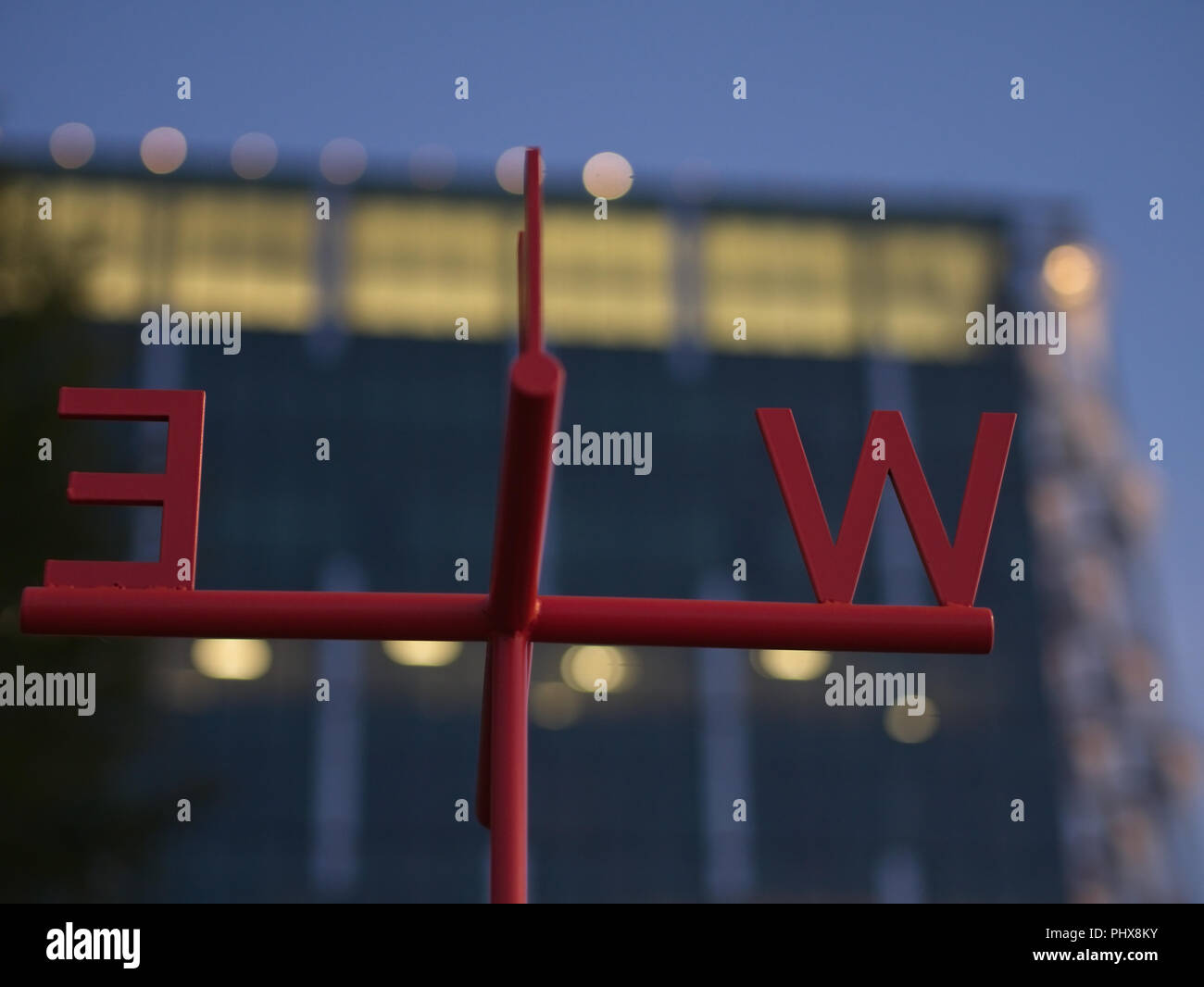 Cardinal direction showing East and West on urban street against ...