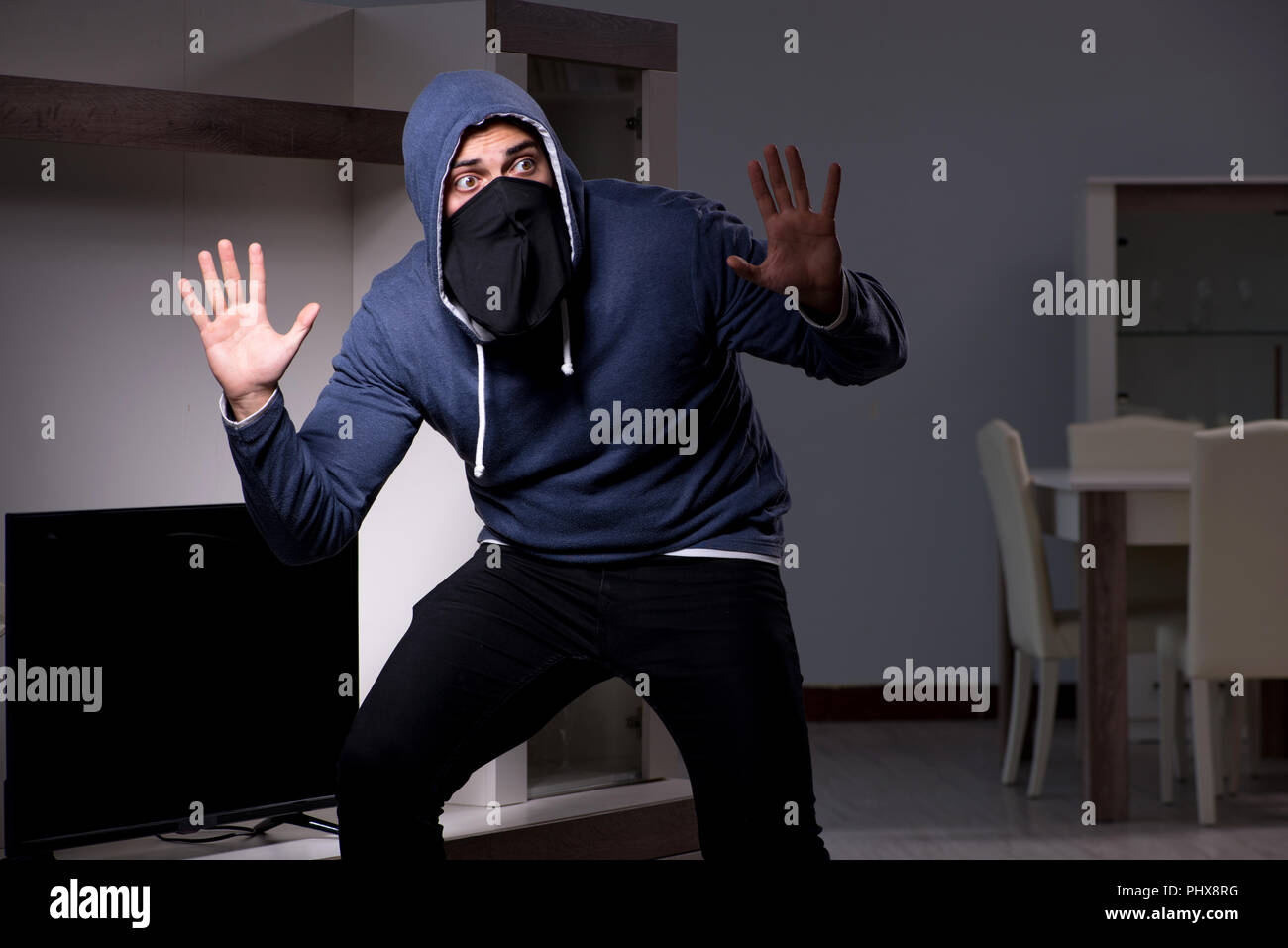 Burglar thief stealing tv from apartment house Stock Photo - Alamy