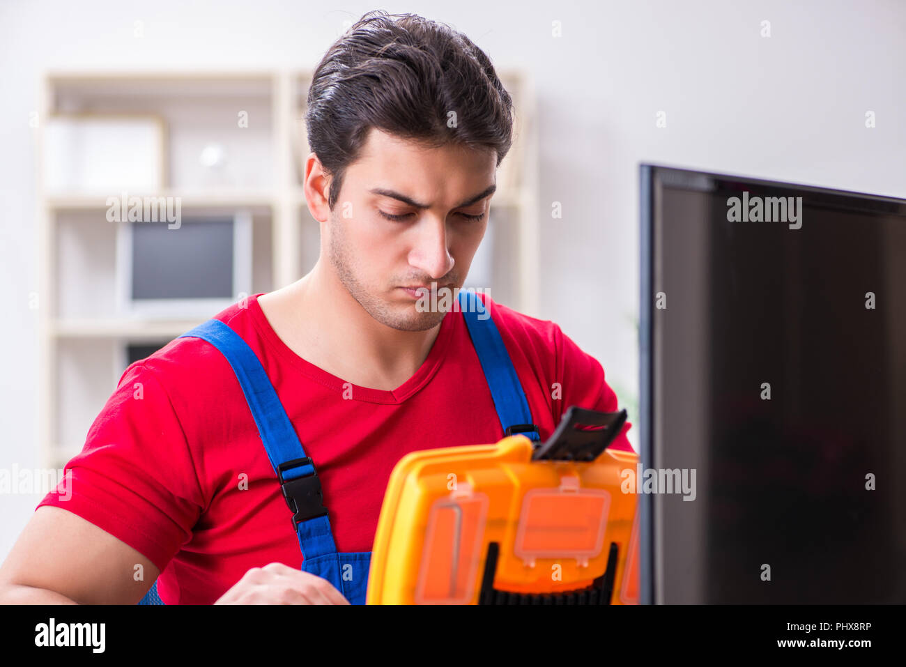 Professional repair engineer repairing broken tv Stock Photo - Alamy