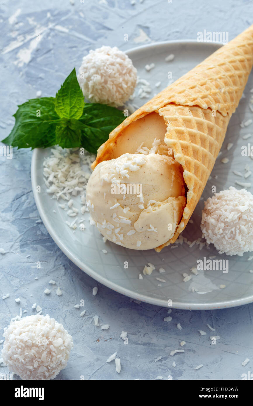 Cone with coconut ice cream and coconut truffle Stock Photo - Alamy