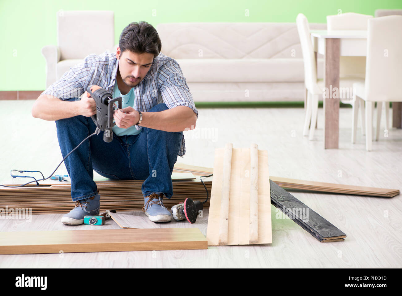Man laying flooring at home Stock Photo - Alamy