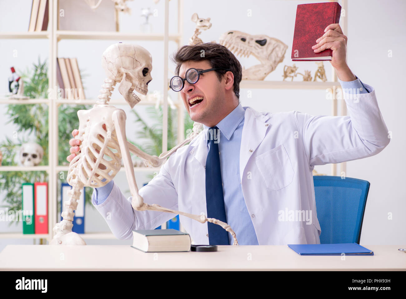 Crazy professor studying human skeleton Stock Photo - Alamy