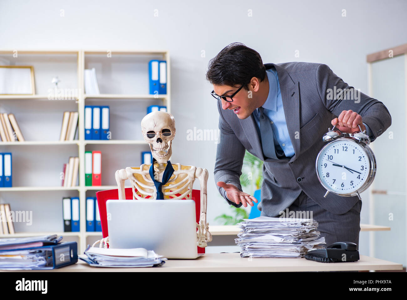 Angry boss yelling at his skeleton employee Stock Photo - Alamy