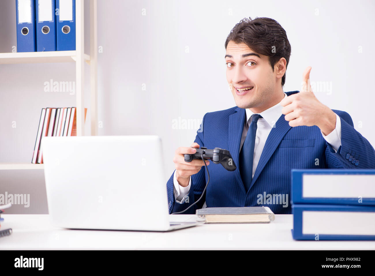 Young handsome businessman playing computer games at work office Stock ...