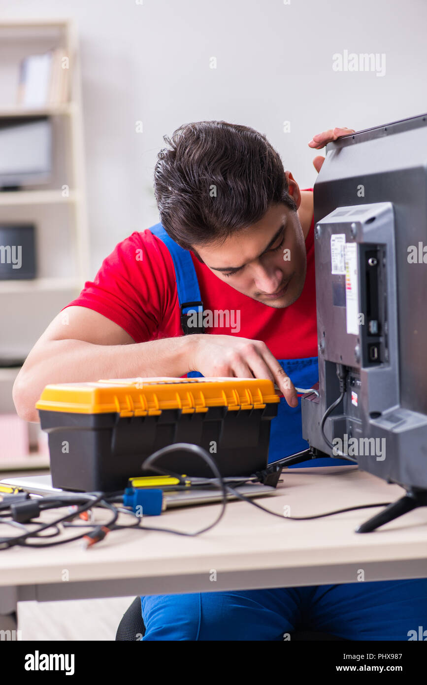 Professional repair engineer repairing broken tv Stock Photo - Alamy