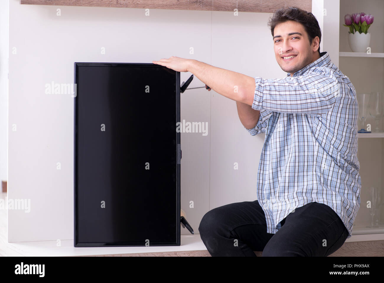 Man repairing broken tv at home Stock Photo - Alamy