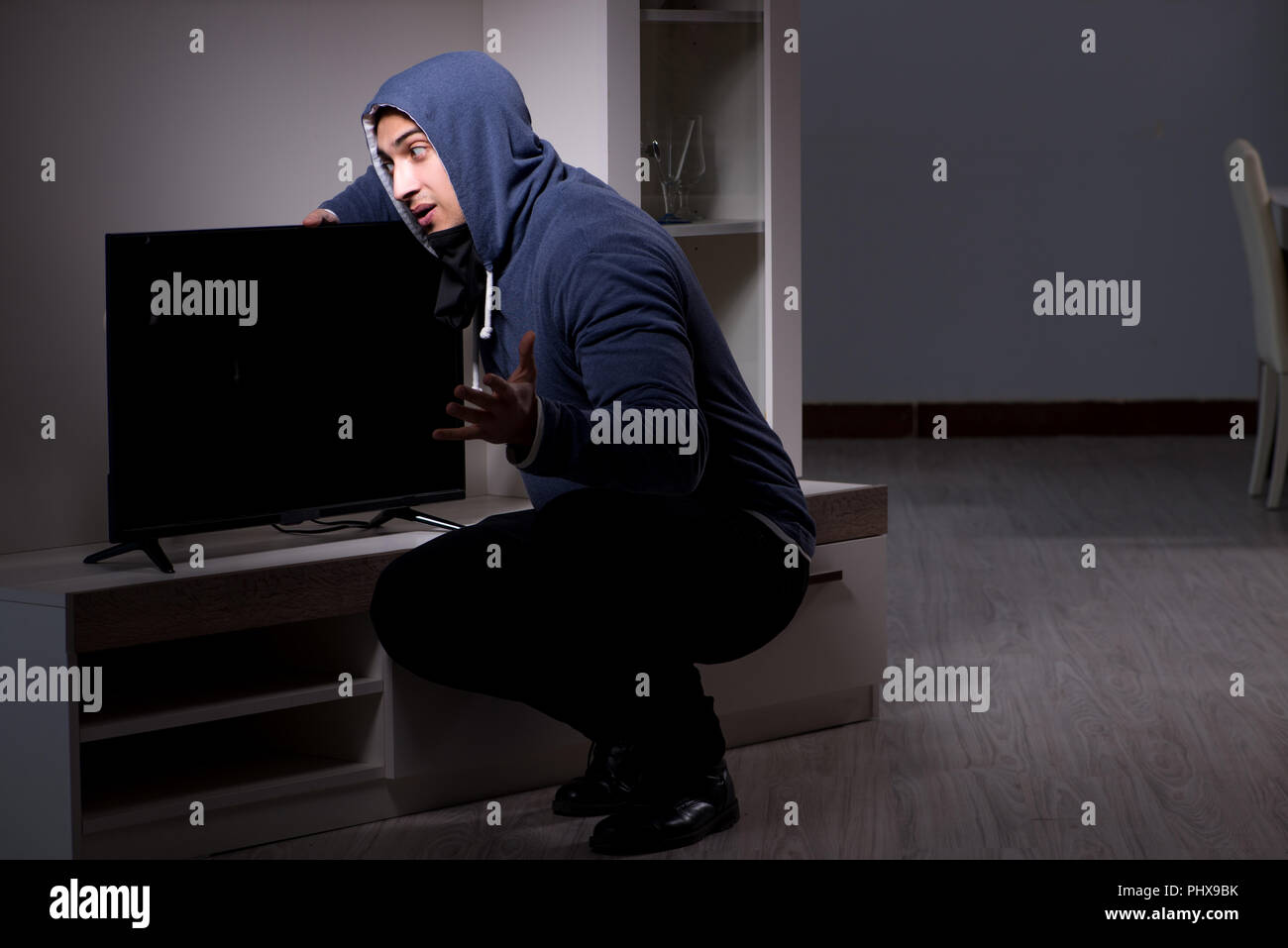 Burglar thief stealing tv from apartment house Stock Photo - Alamy