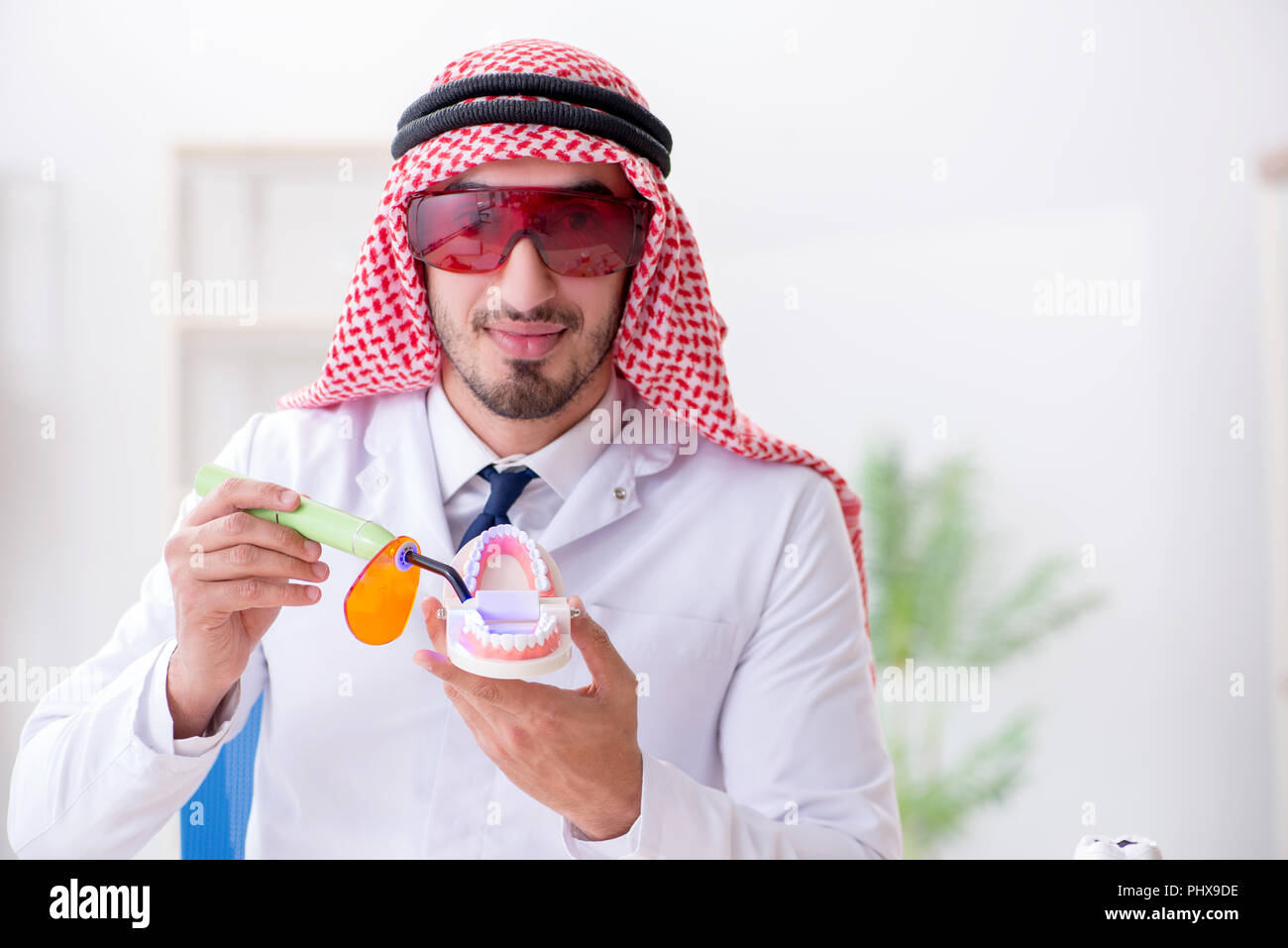 Arab dentist working on new teeth implant Stock Photo - Alamy