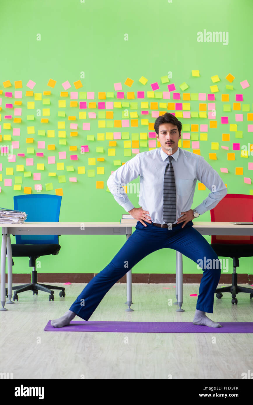 Man in the office with many conflicting priorities doing exercis Stock ...