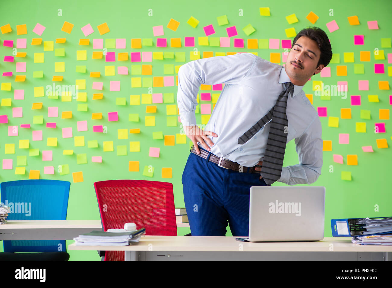 Man in the office with many conflicting priorities doing exercis Stock ...
