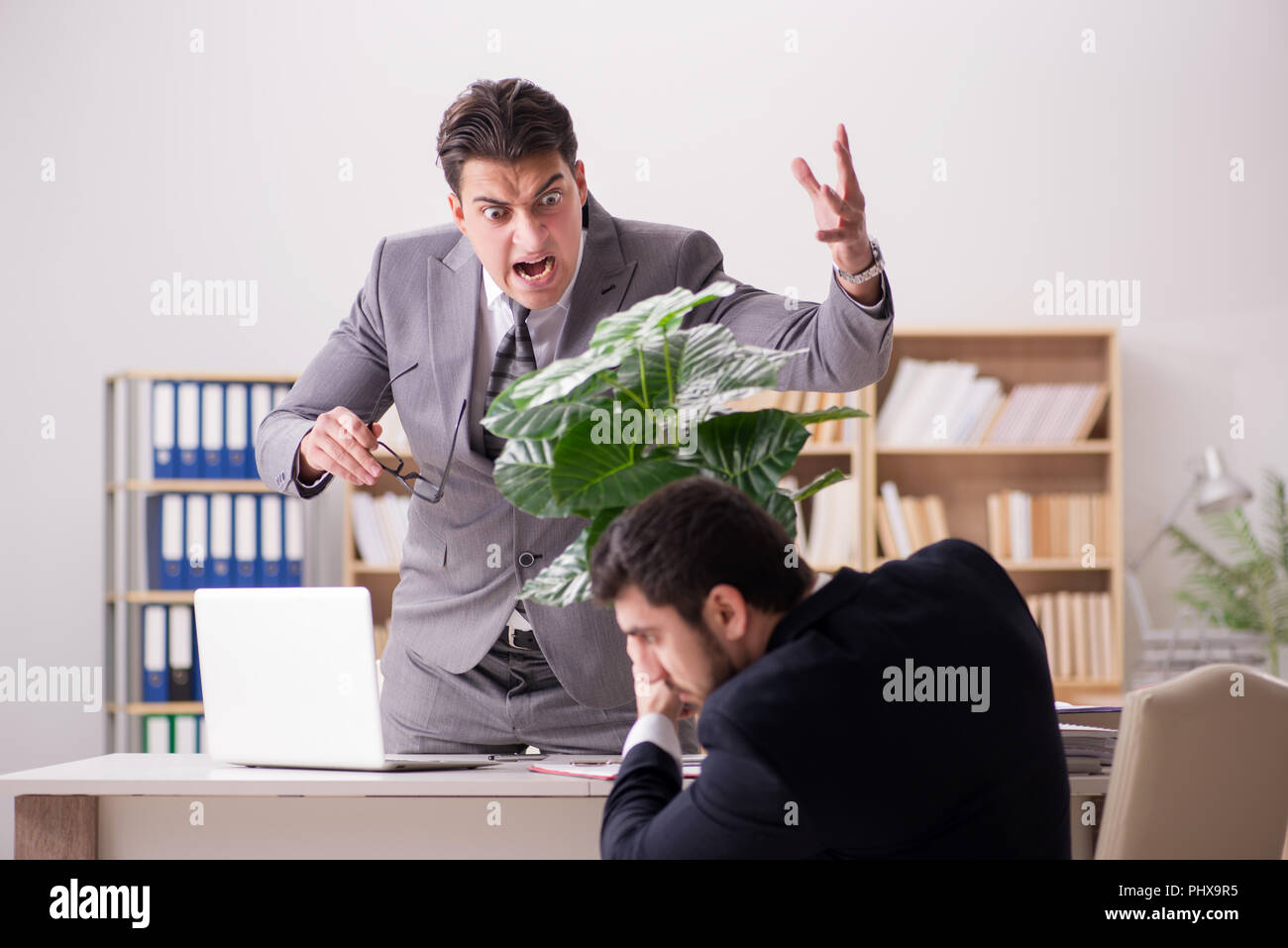 Angry boss shouting at his employee Stock Photo - Alamy
