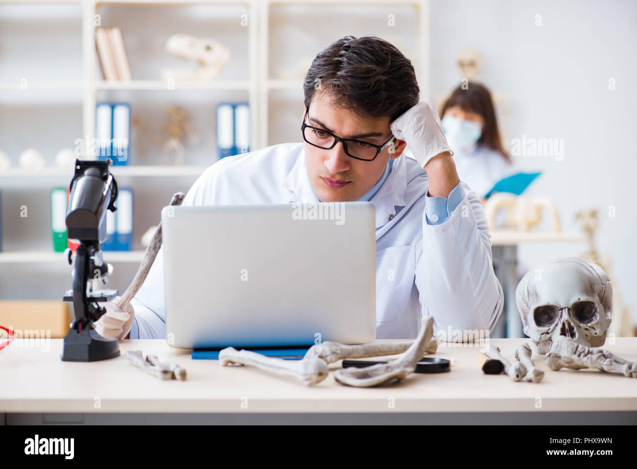Professor studying human skeleton in lab Stock Photo - Alamy