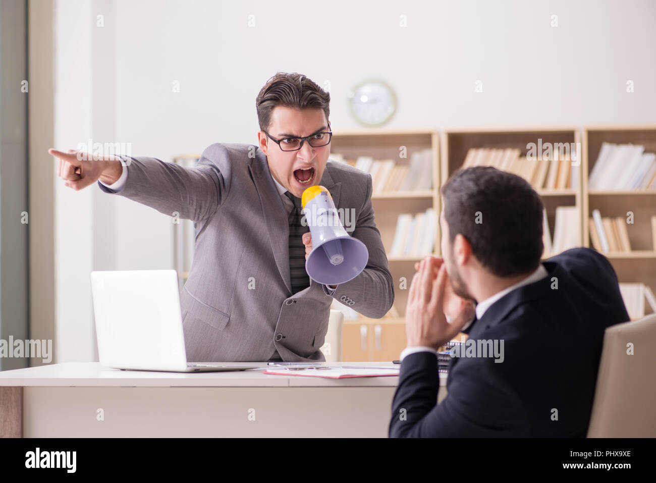 Angry boss shouting at his employee Stock Photo - Alamy