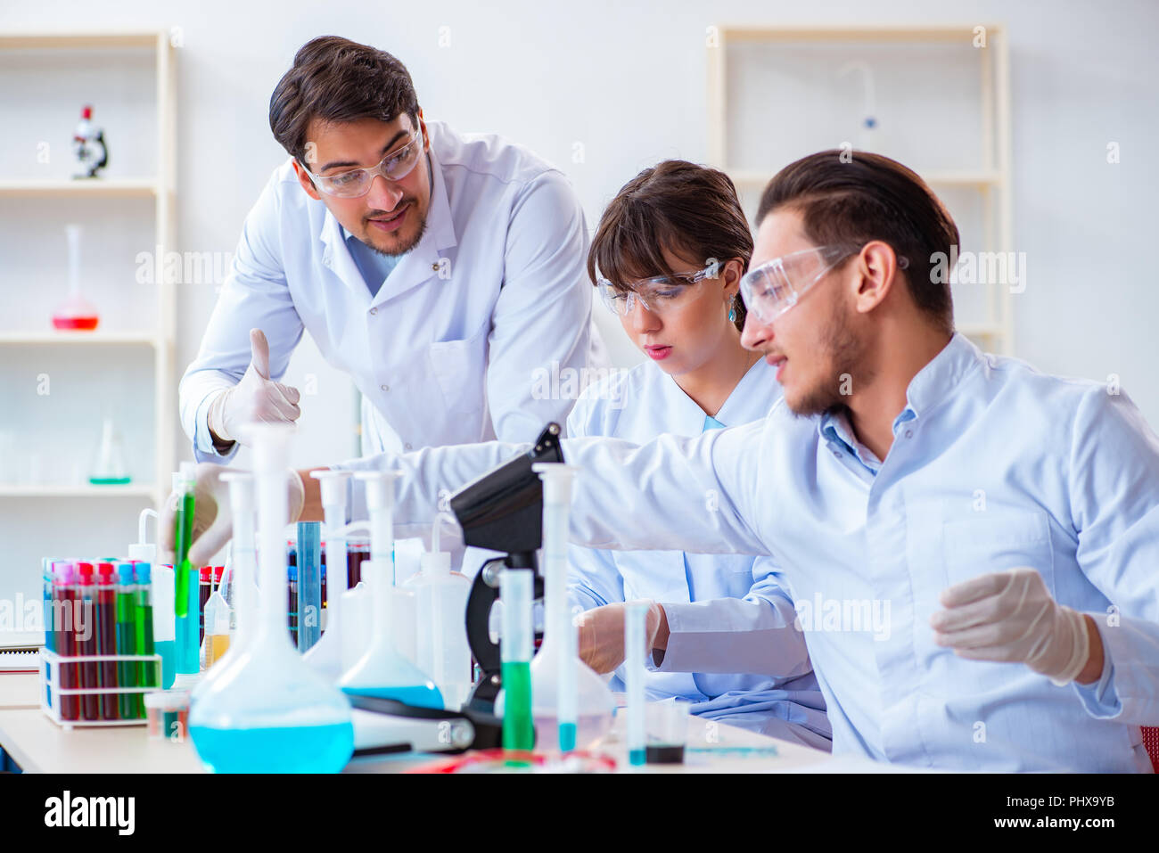 Team of chemists working in the lab Stock Photo - Alamy