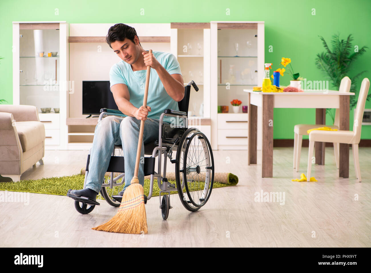Disabled man on wheelchair cleaning house Stock Photo - Alamy