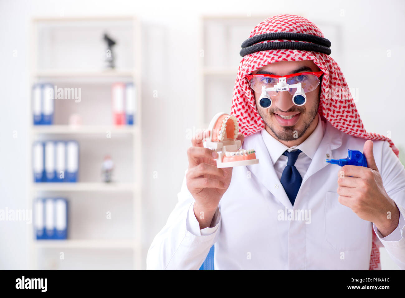 Arab dentist working on new teeth implant Stock Photo - Alamy
