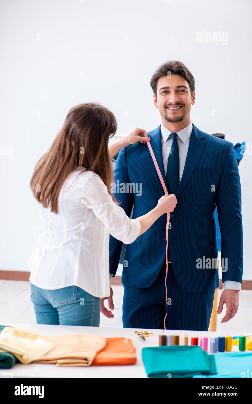 Professional tailor taking measurements for formal suit Stock Photo - Alamy