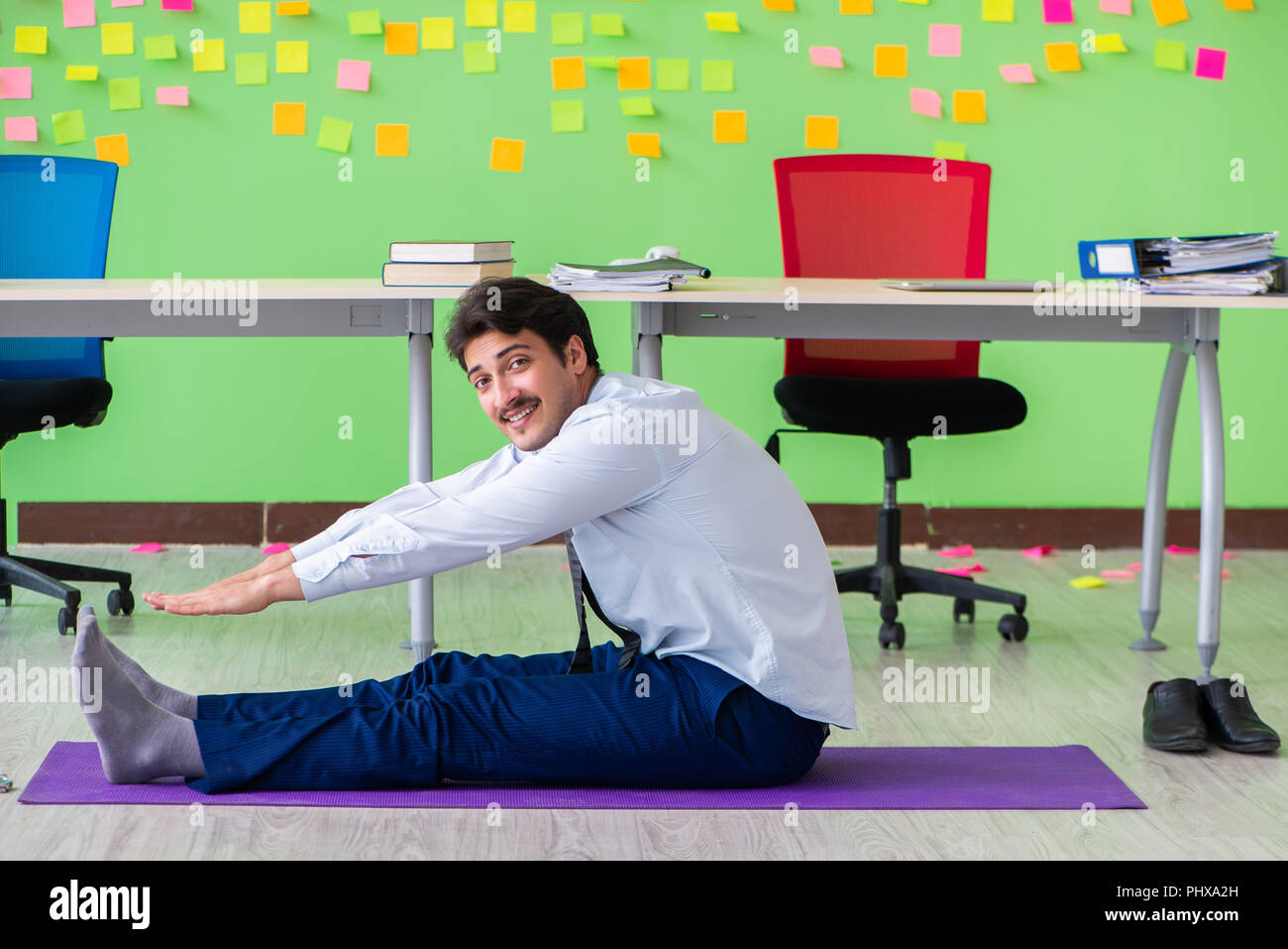 Man in the office with many conflicting priorities doing exercis Stock ...