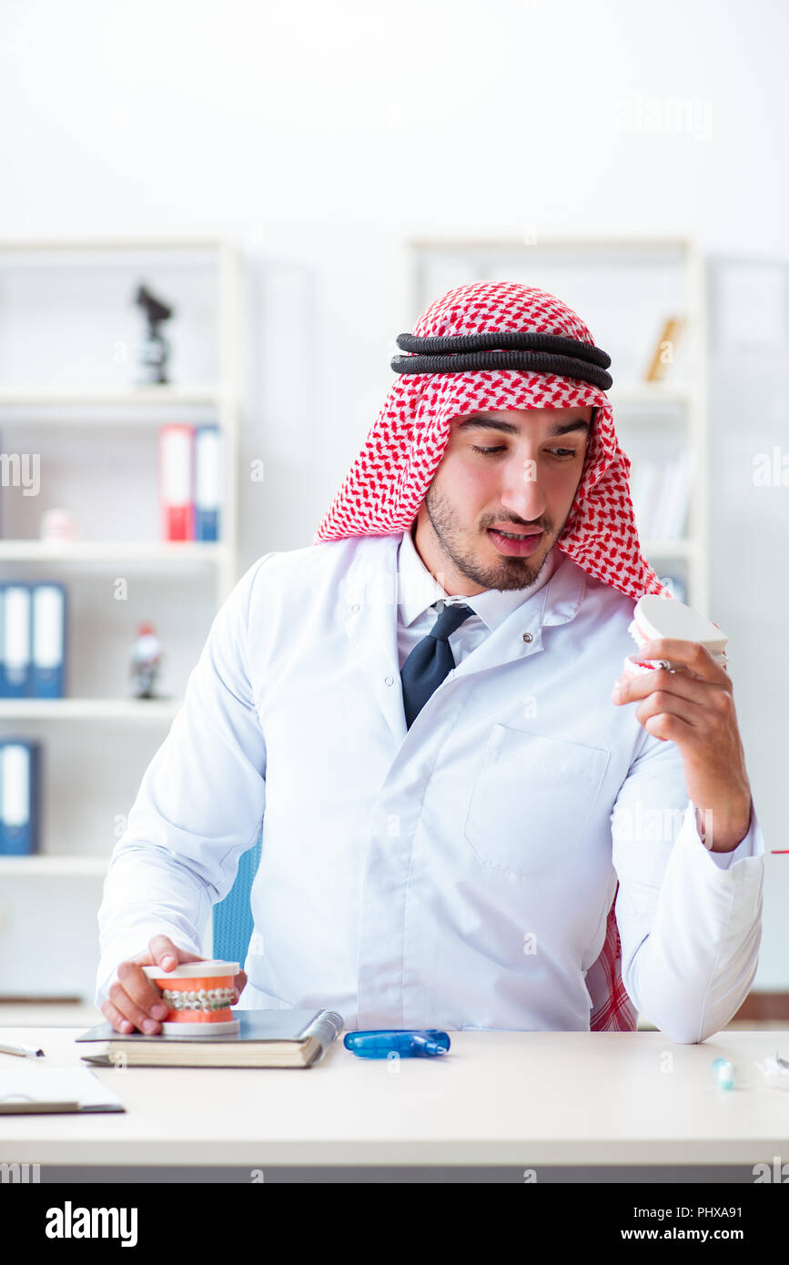 Arab dentist working on new teeth implant Stock Photo - Alamy