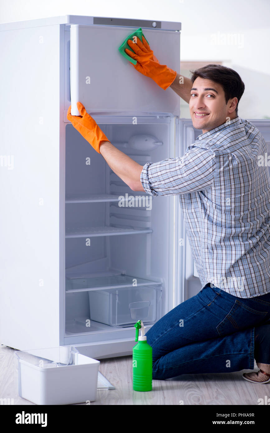Man cleaning fridge in hygiene concept Stock Photo - Alamy