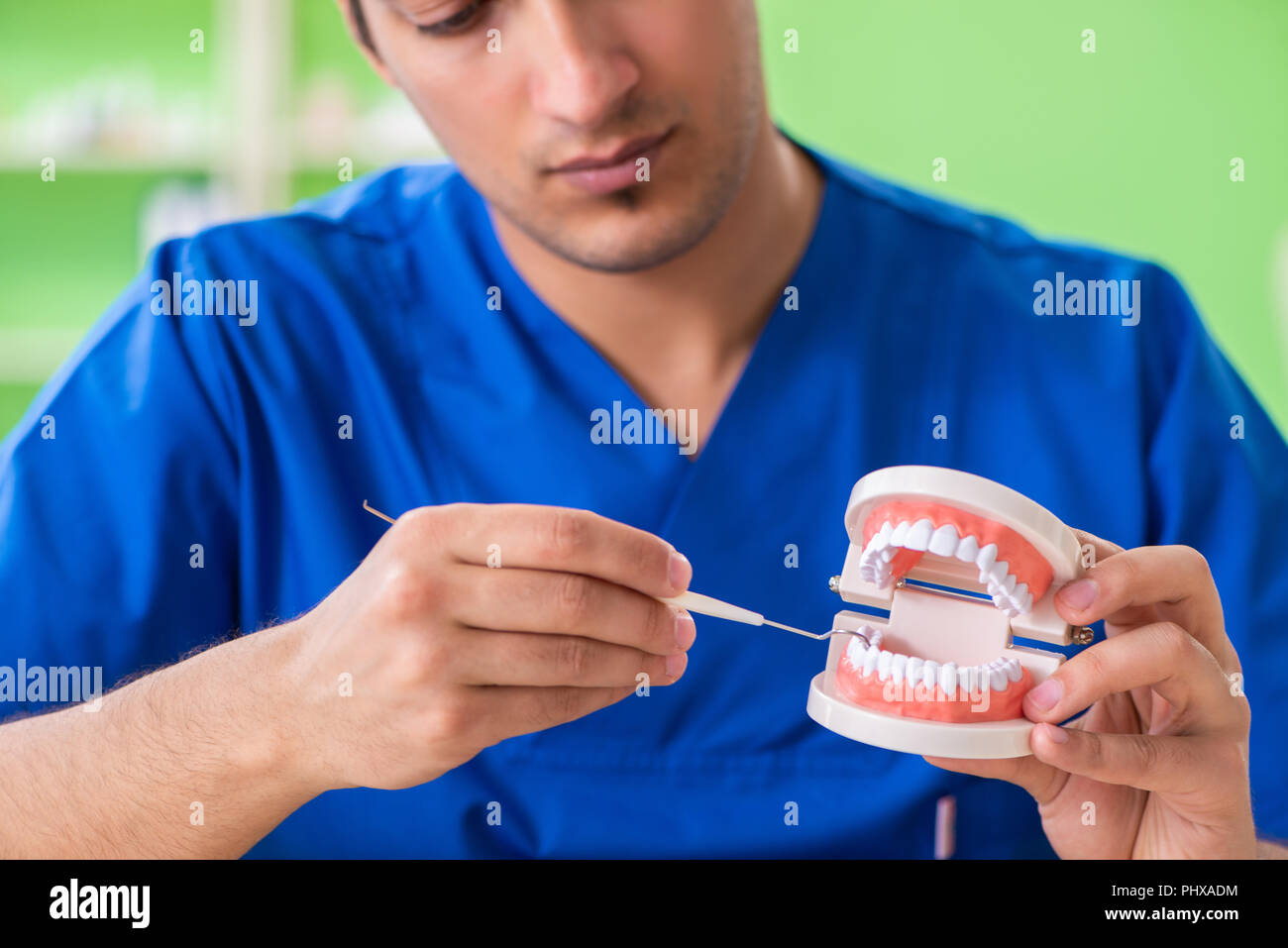 Man dentist working on new teeth implant Stock Photo - Alamy