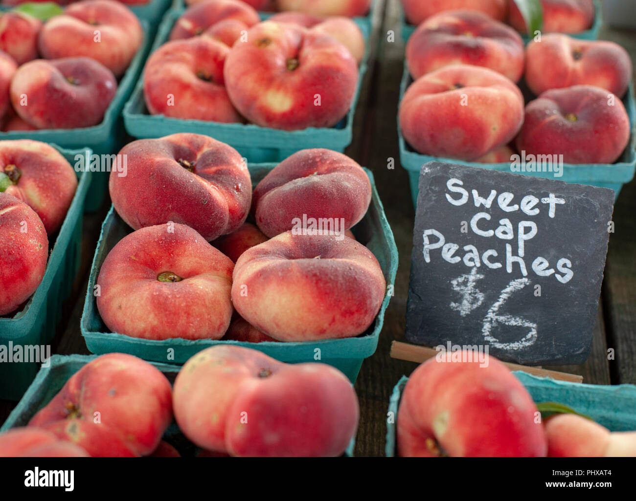 Sweet cap peaches, also called donut peaches, on sale at the Ithaca ...