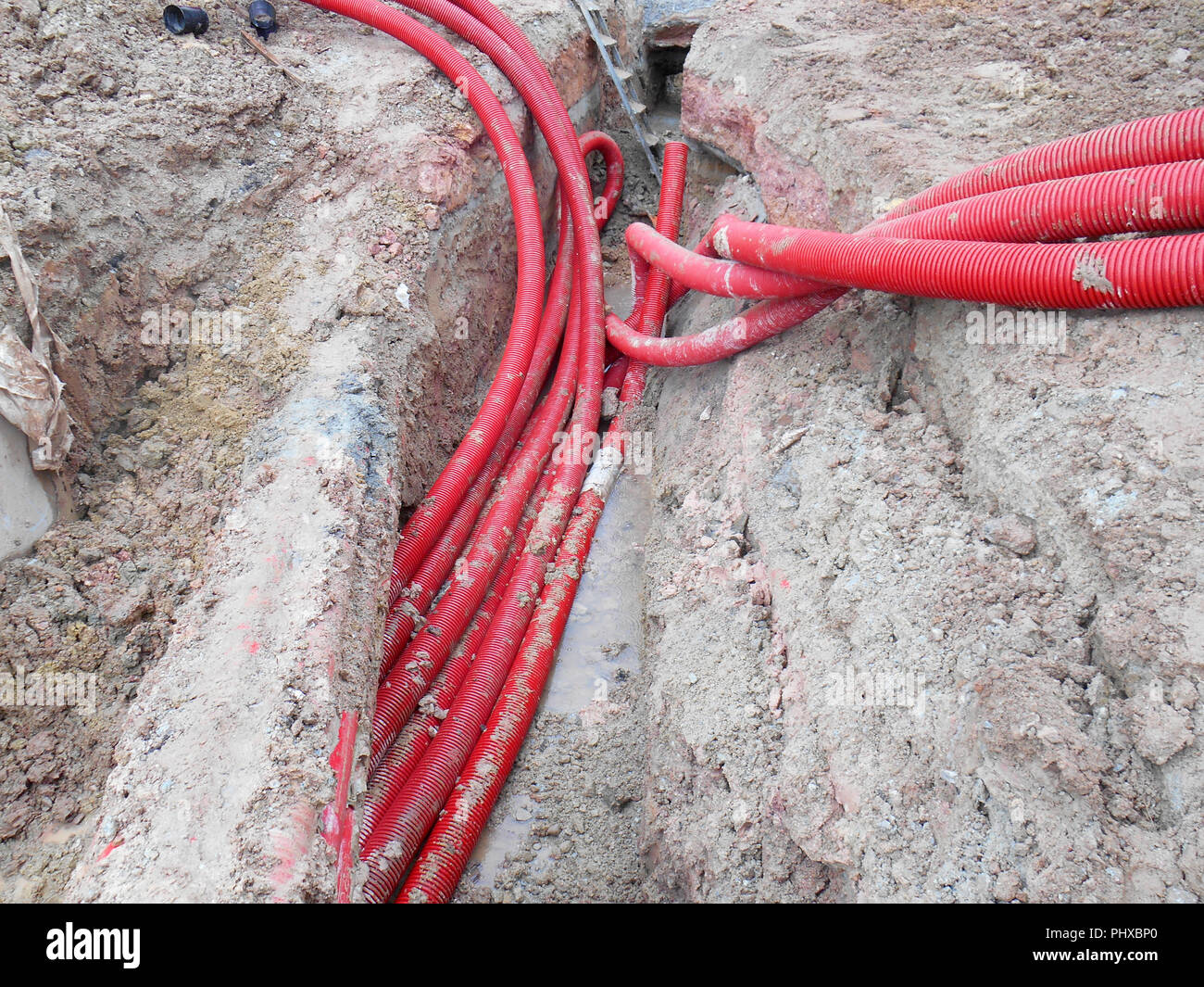 Underground utility and services pipe laid by workers in the trenches ...