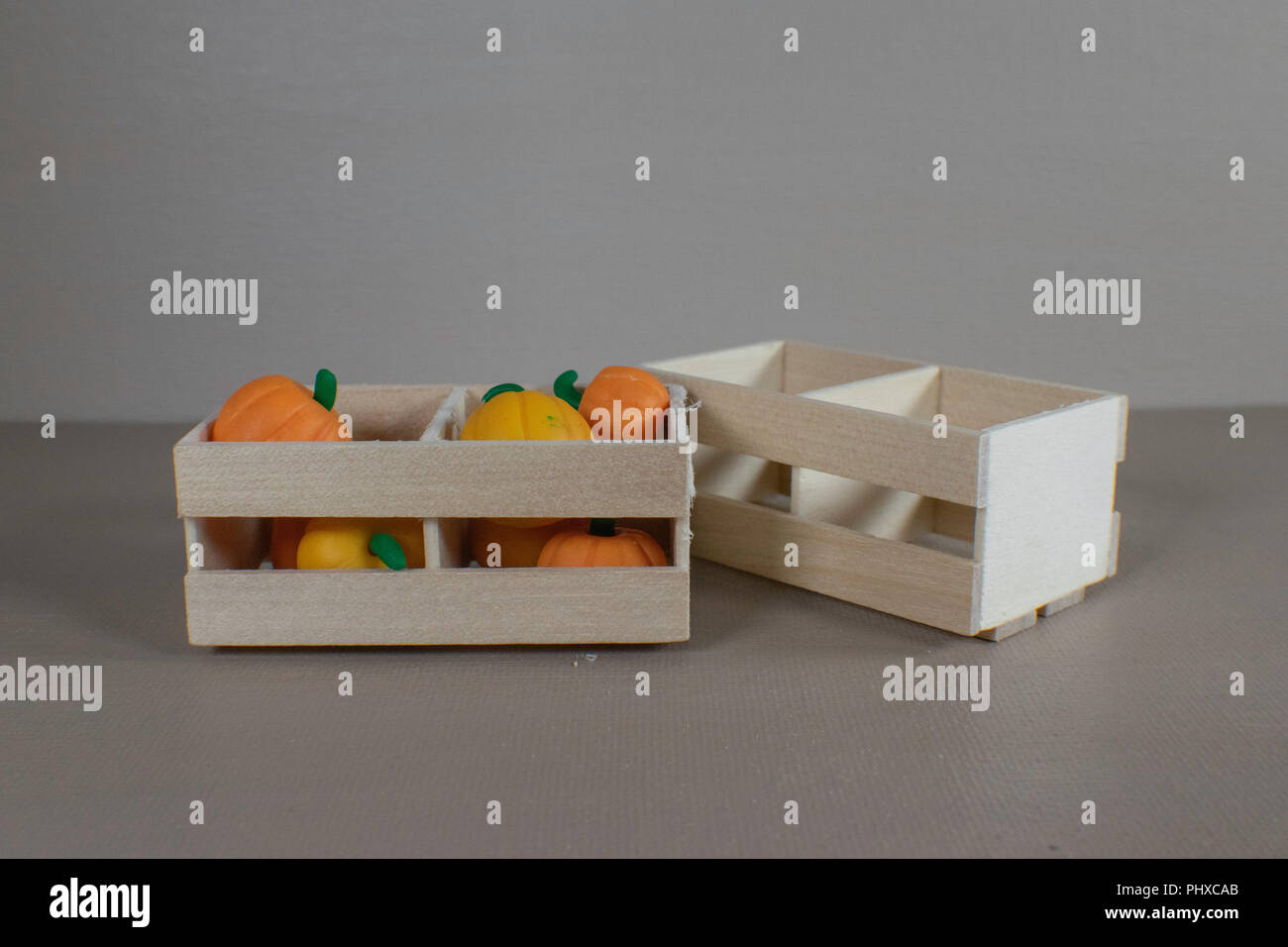 A pair of handmade wooden crates one filled with fake pumpkins and the ...