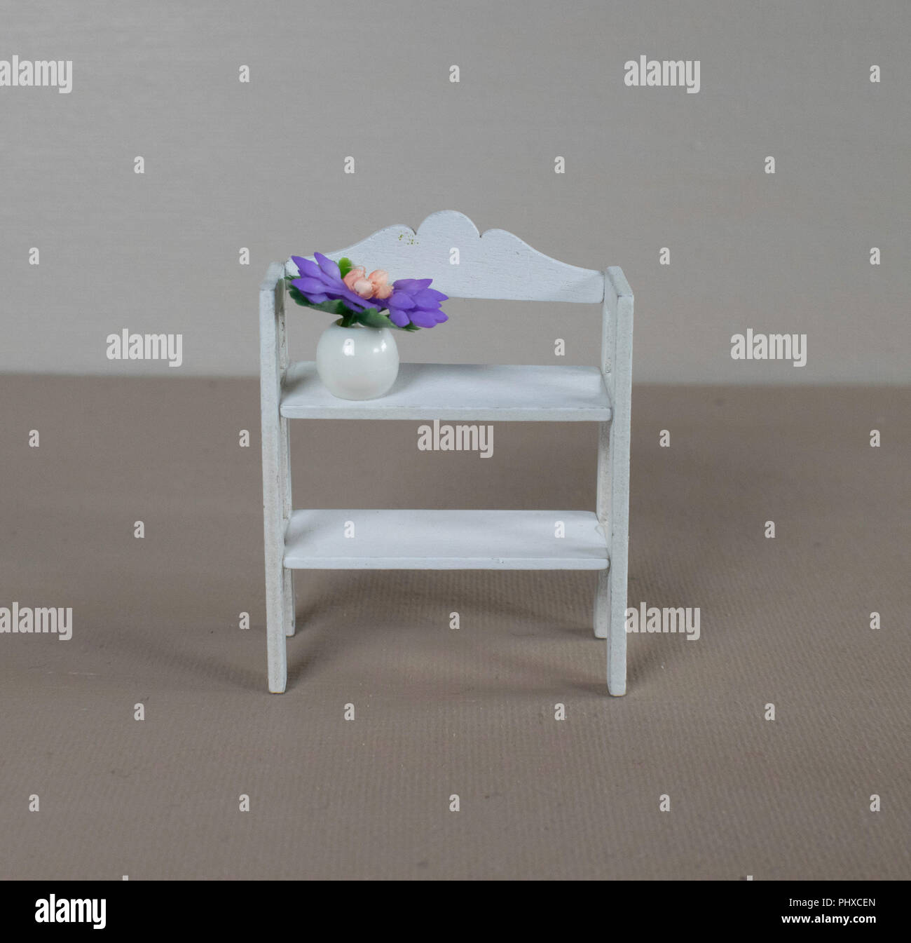 Handmade white wooden shelves with a fake pot plant sitting on the top ...