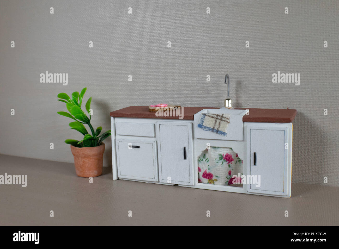 Handmade kitchen sink and cupboards with a fake plant in a pot Stock ...