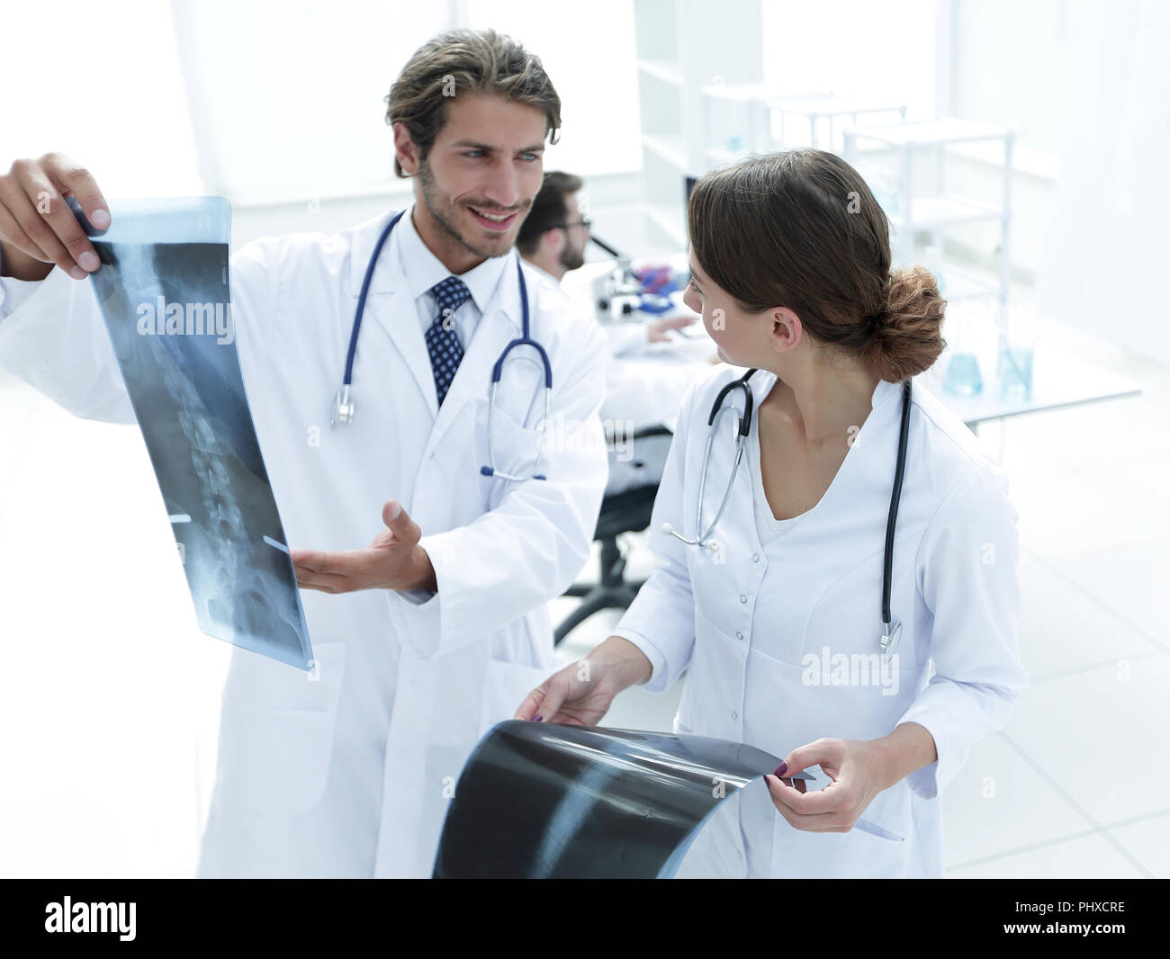 Male surgeon with nurse examining x-ray report Stock Photo - Alamy