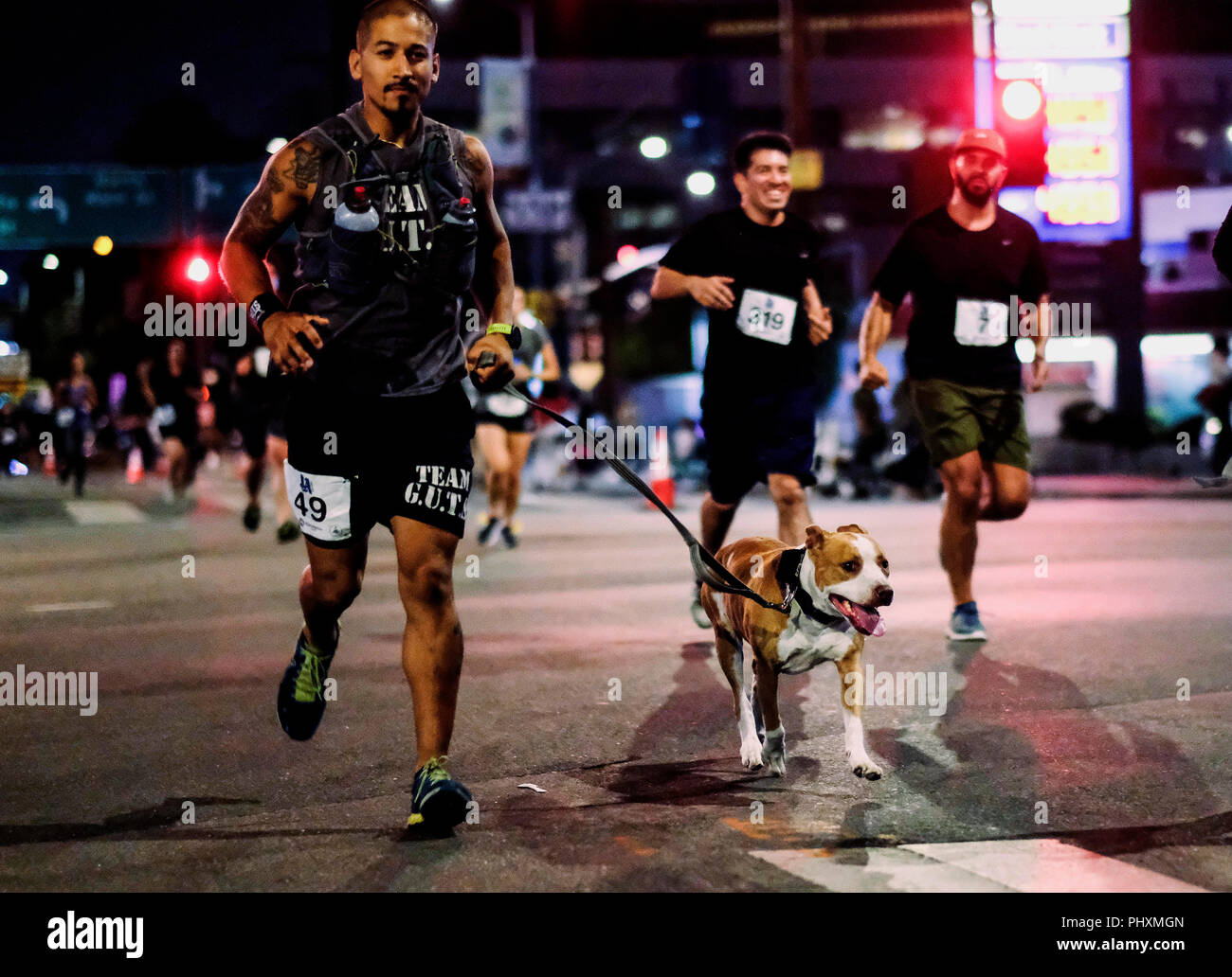Los Angeles, USA. 2nd Sep, 2018. A participant runs with his dog during ...