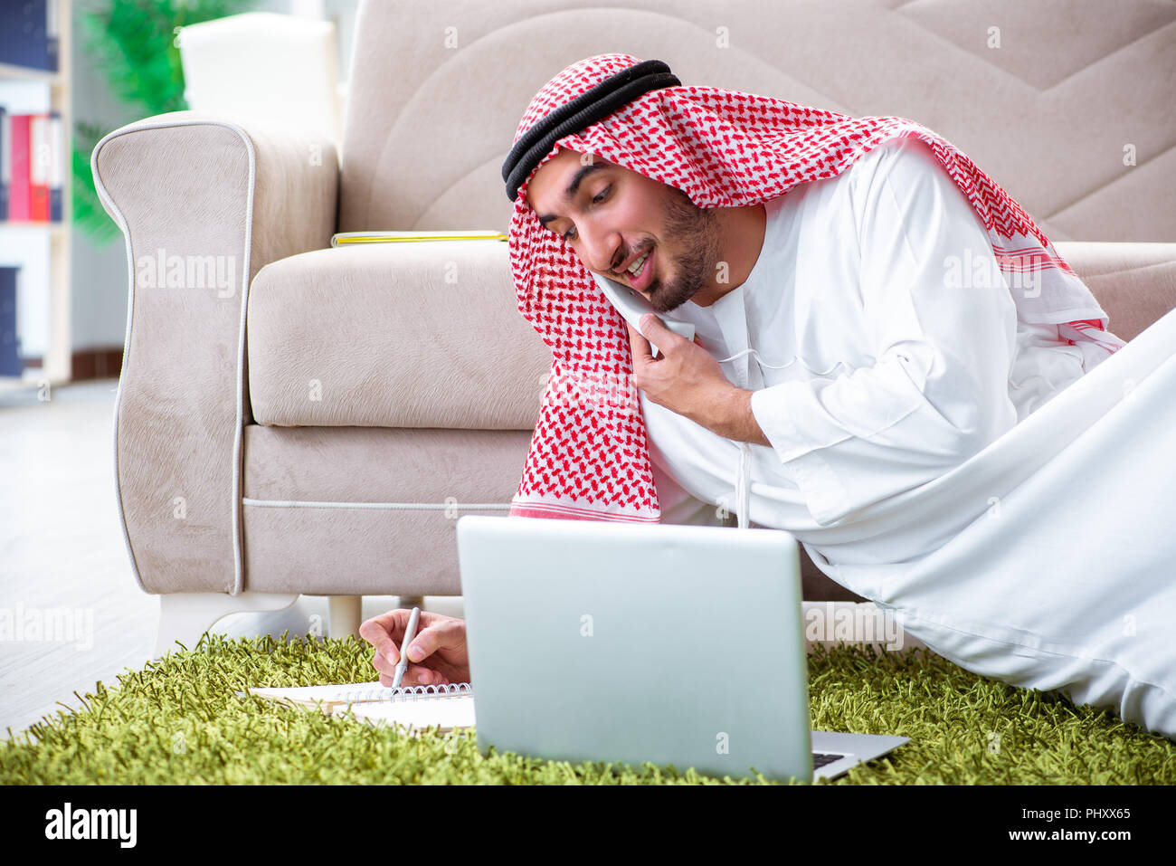 Arab man working at home on his work Stock Photo - Alamy