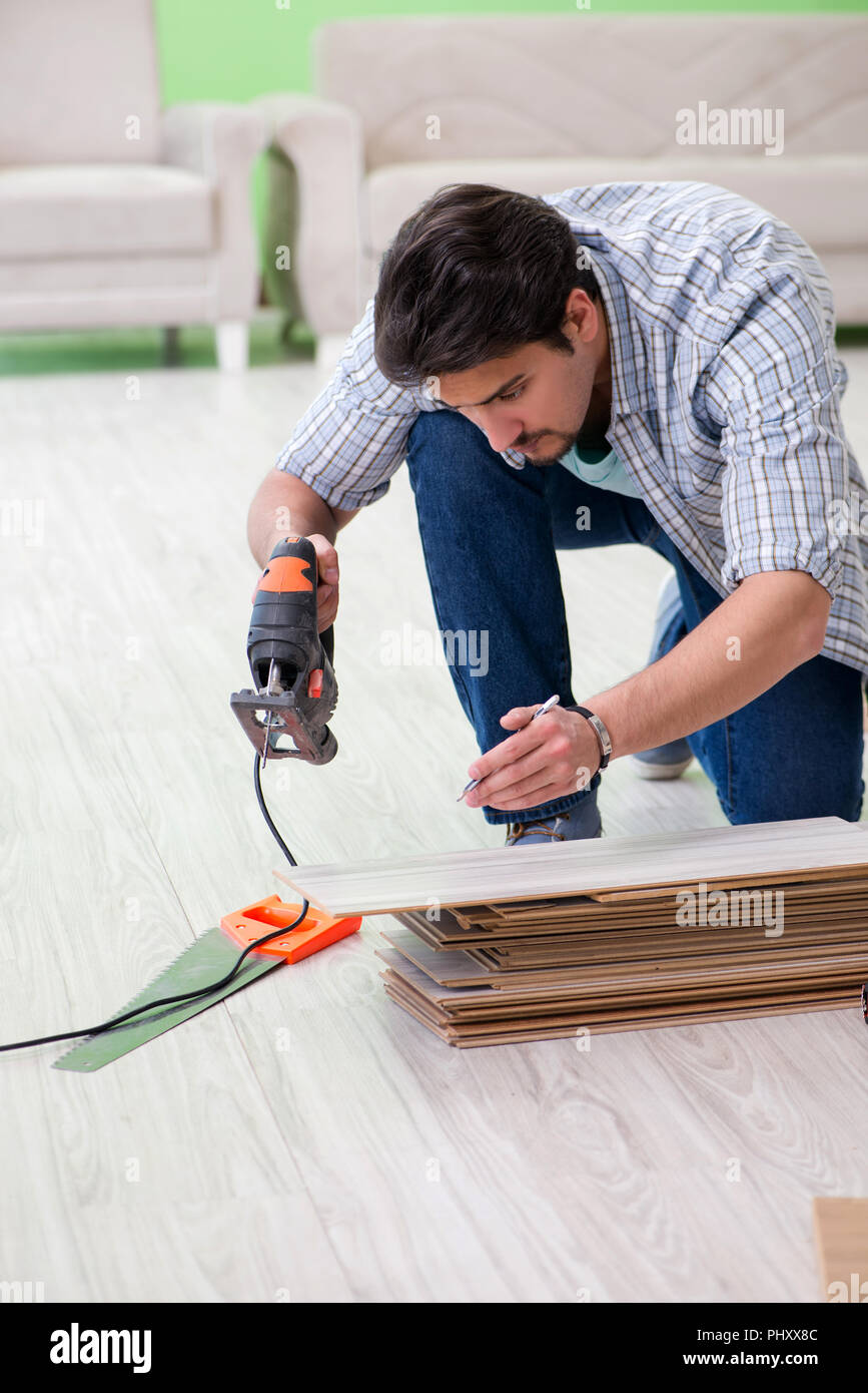 Man laying flooring at home Stock Photo - Alamy