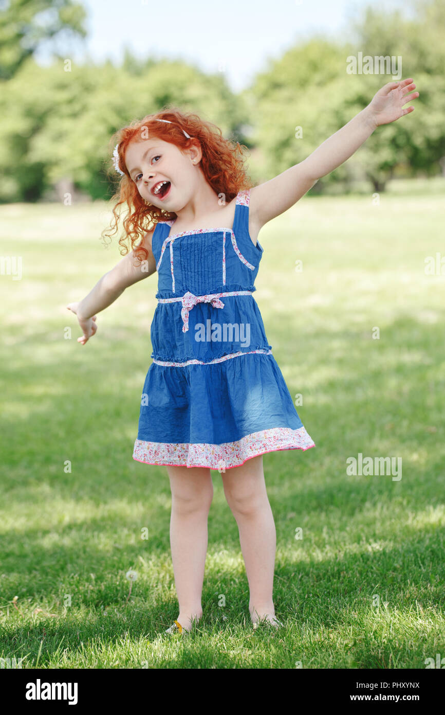 Portrait of cute adorable little red-haired Caucasian girl child in ...