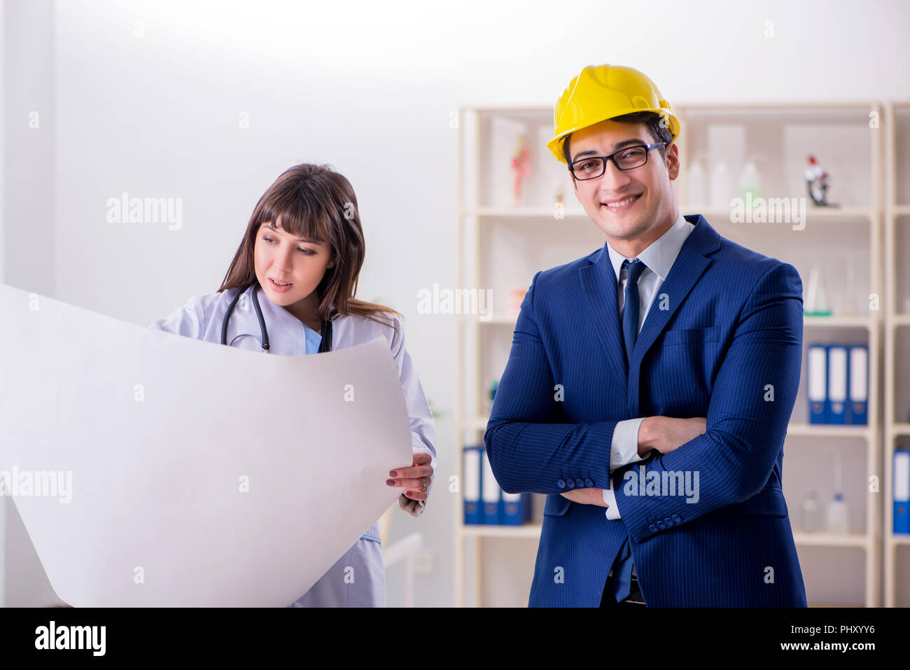 Doctor discussing new hospital plan with architect Stock Photo - Alamy