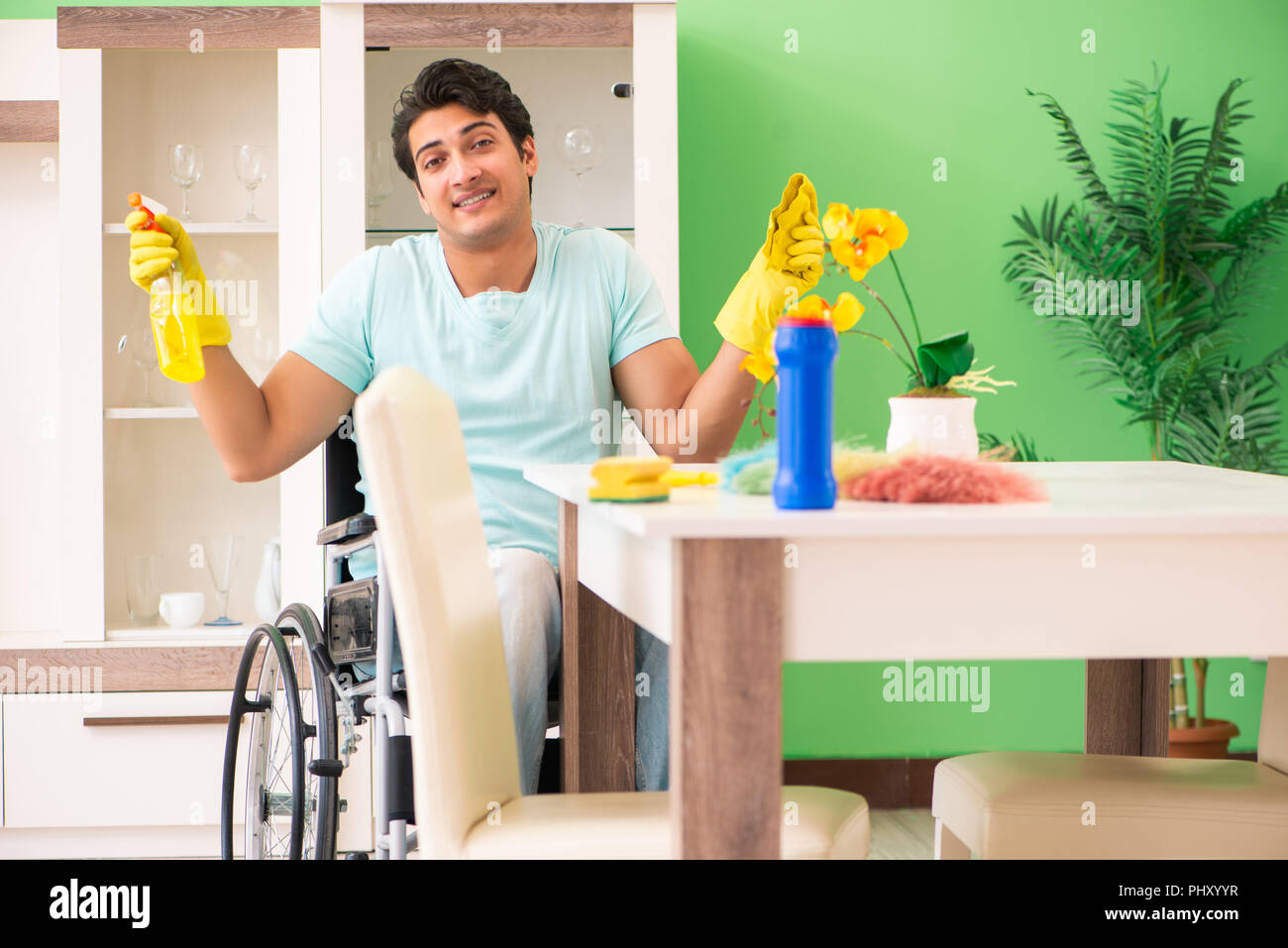 Disabled man on wheelchair cleaning house Stock Photo - Alamy