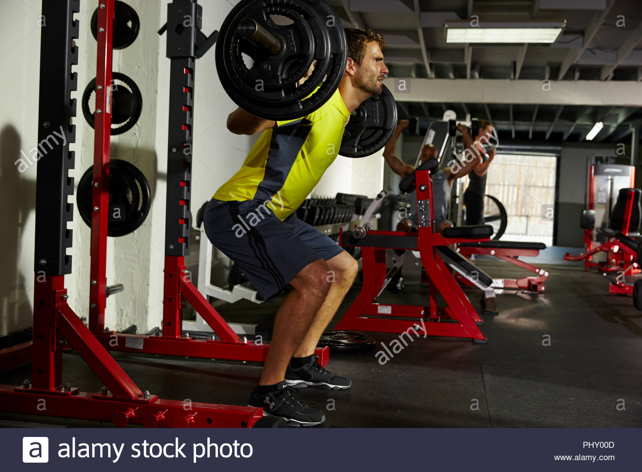 Man Squatting Gym High Resolution Stock Photography and Images - Alamy