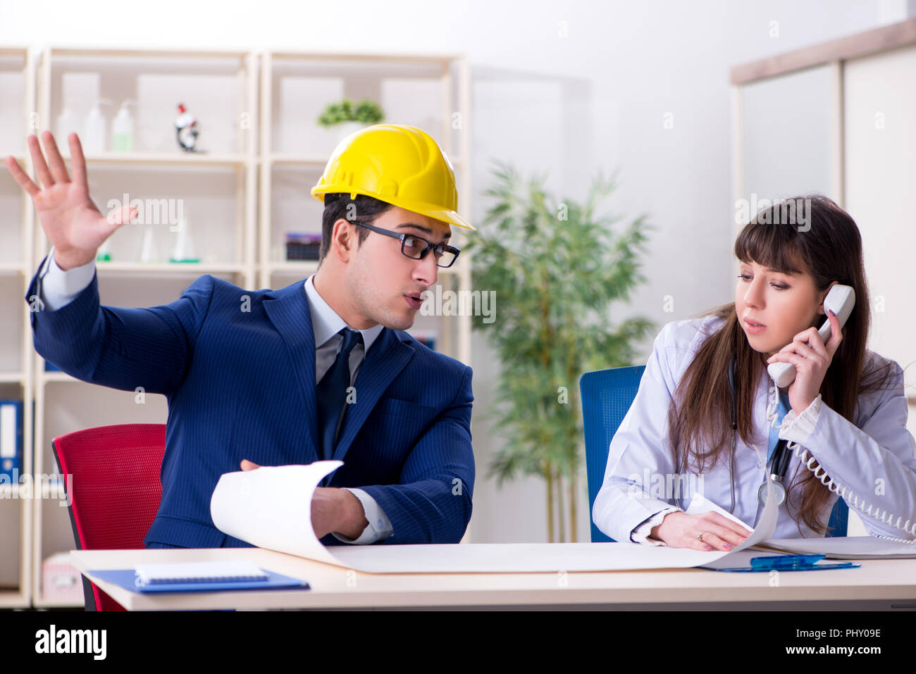 Doctor discussing new hospital plan with architect Stock Photo - Alamy
