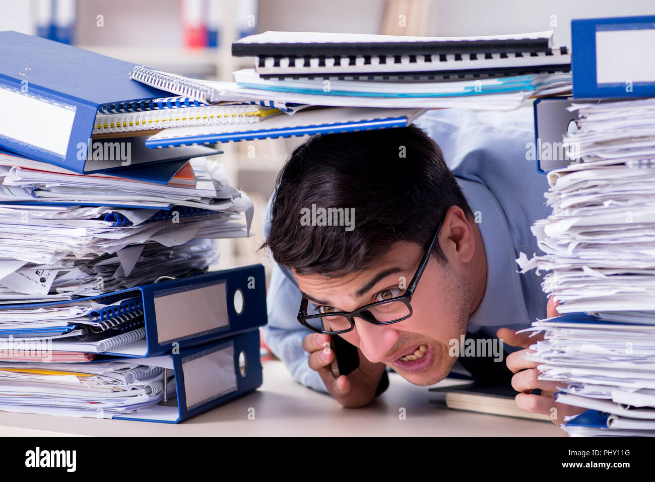 Extremely busy businessman working in office Stock Photo - Alamy