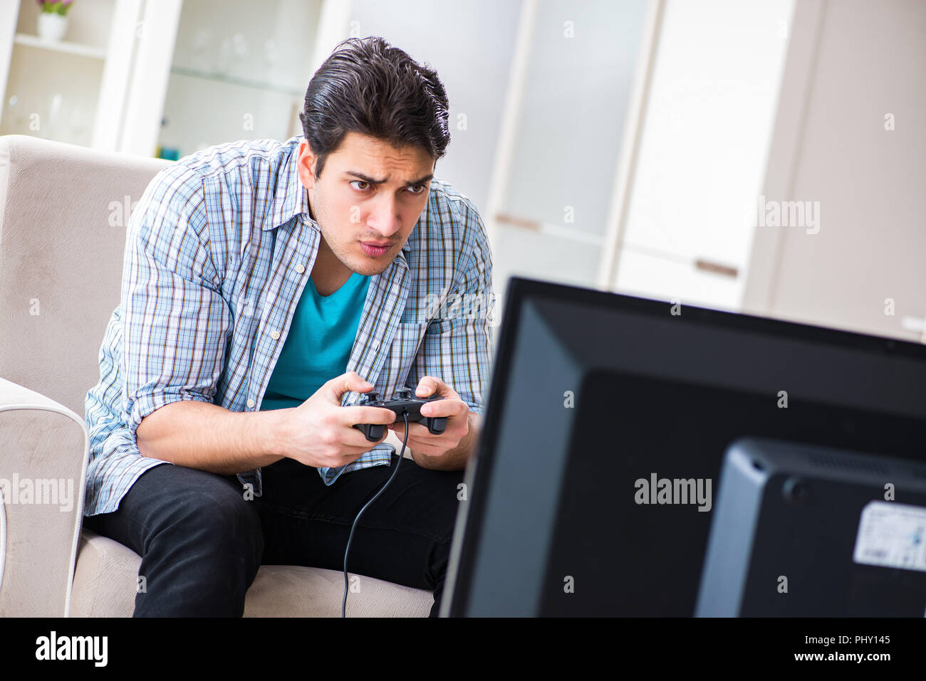 Man playing computer game at home Stock Photo - Alamy