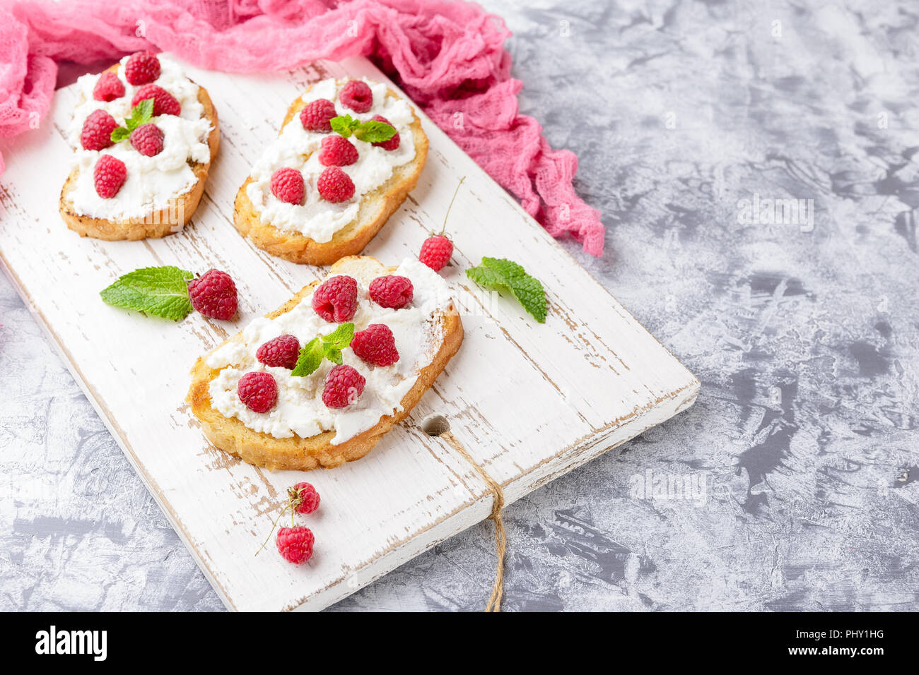 Breakfast slice of bread with Ricotta cheese served with raspberries ...
