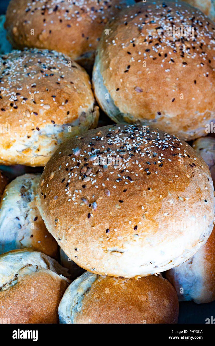 Close-up of a pile of multigrain-coated "brun pav" loaves (hard-crust ...
