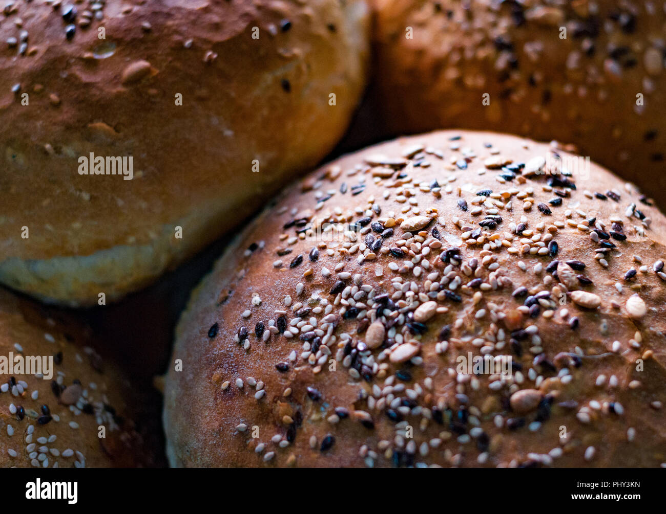 Close-up of a pile of multigrain-coated "brun pav" loaves (hard-crust ...