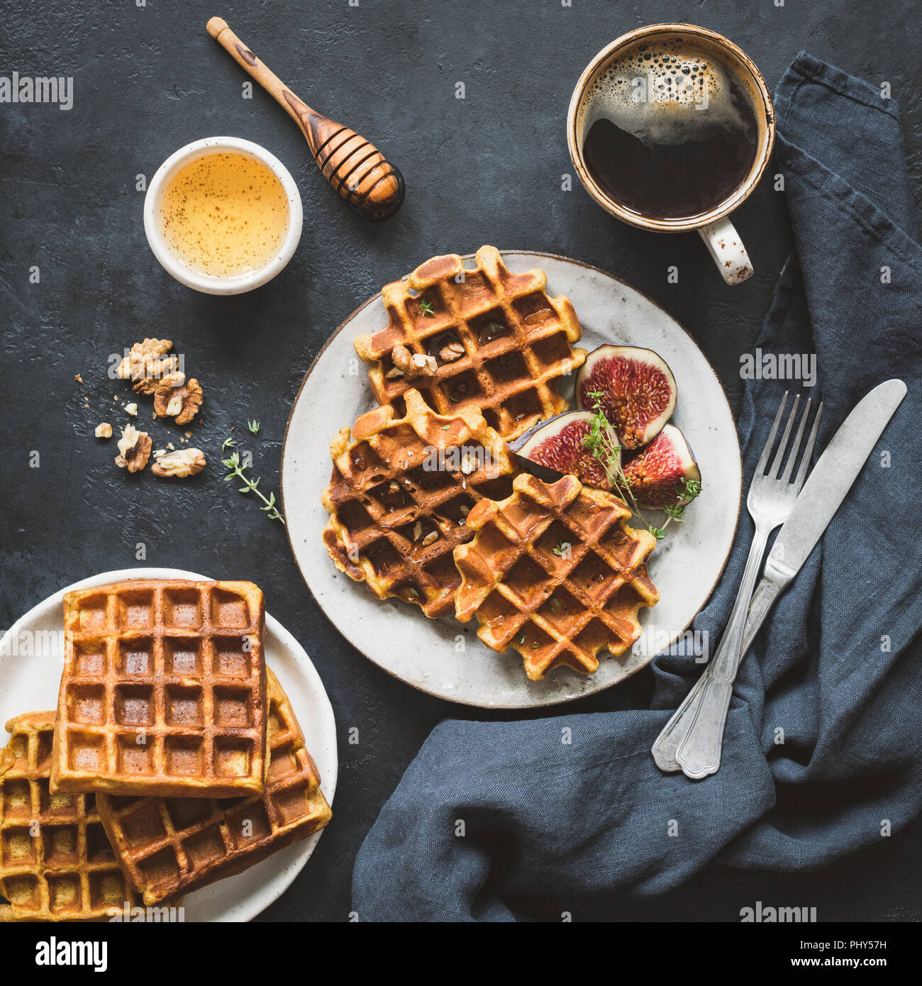 Belgian waffles with figs and honey for breakfast on black background ...