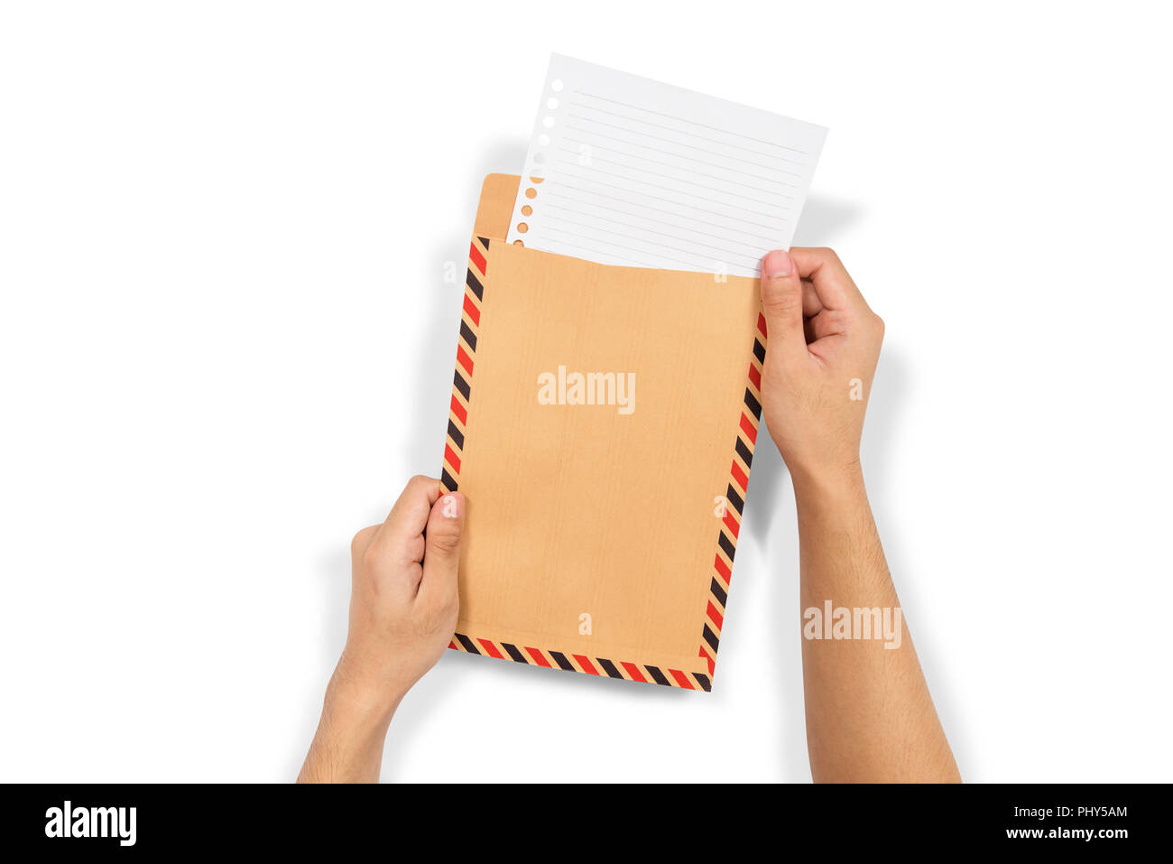 Hands insert the paper into brown envelope isolated over white ...