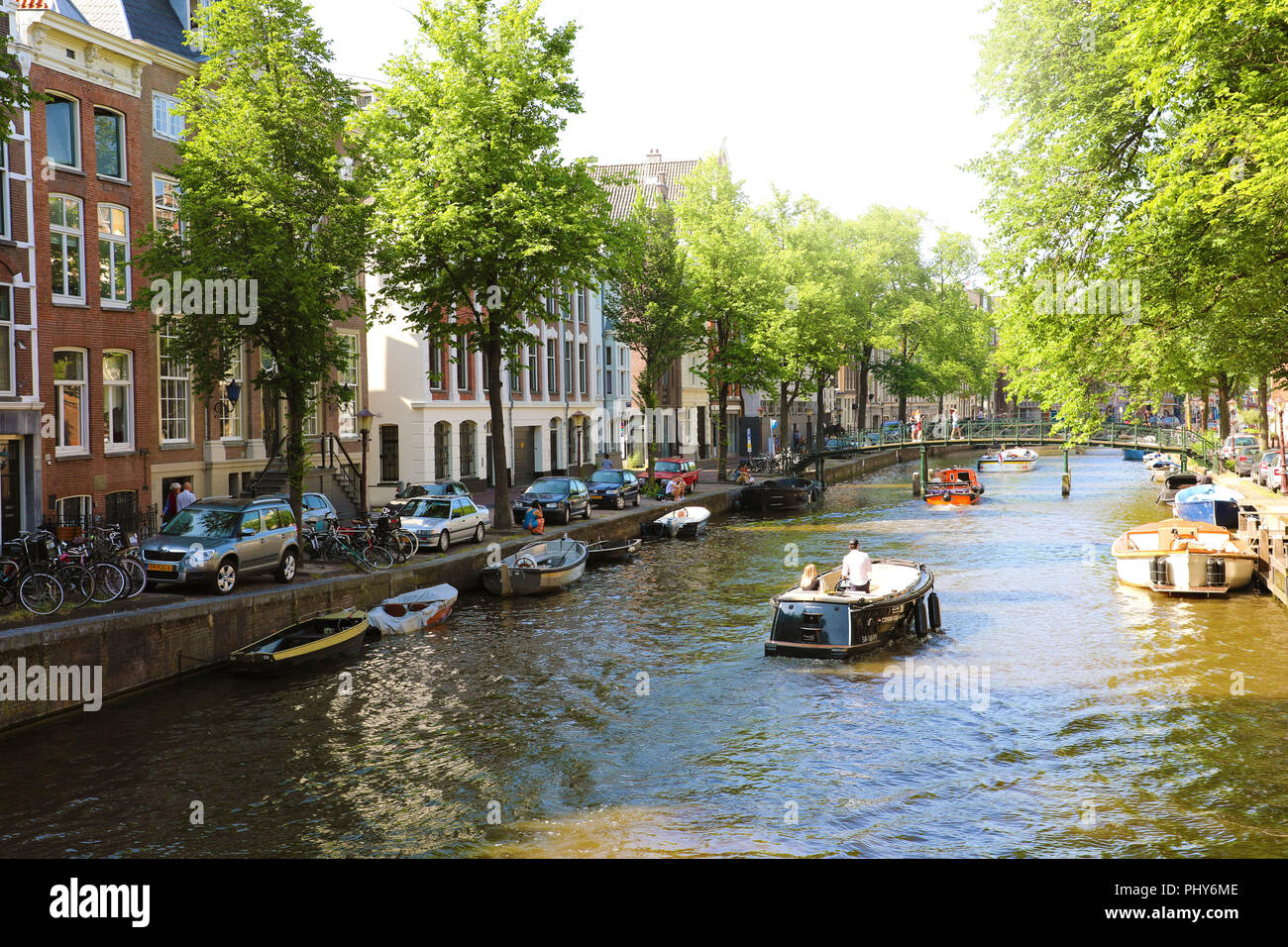 AMSTERDAM, NETHERLANDS - JUNE 6, 2018: channel in Amsterdam with houses ...